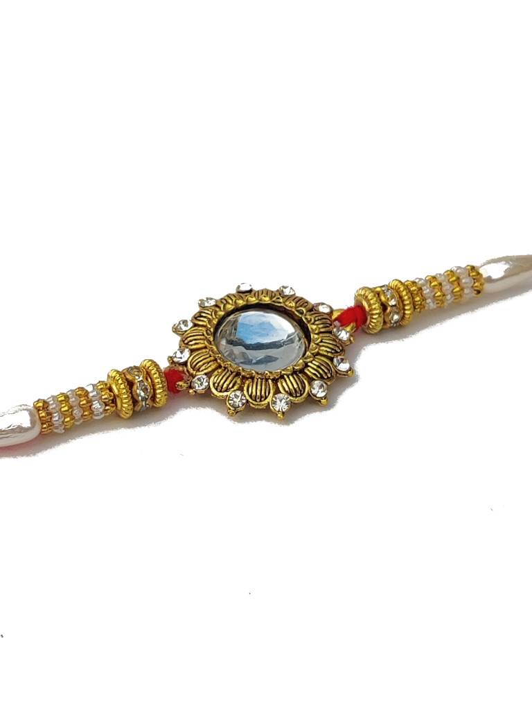 Crystal Rakhi Embraced by Golden Blossom and Royal Design + Roli ...