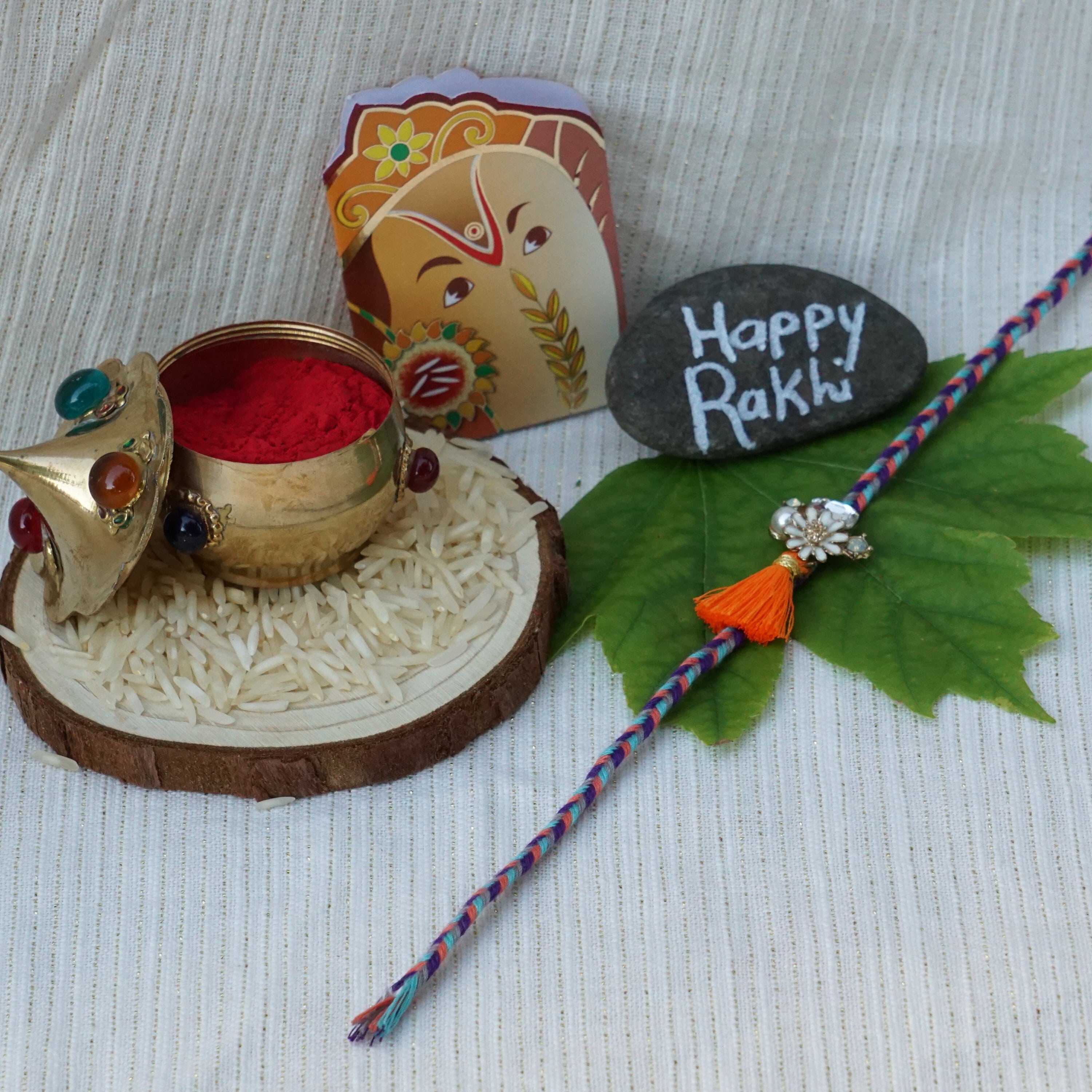 UtsaWe GIFT HAMPER - Adorable Rakhi With Orange Tassel and Square ...